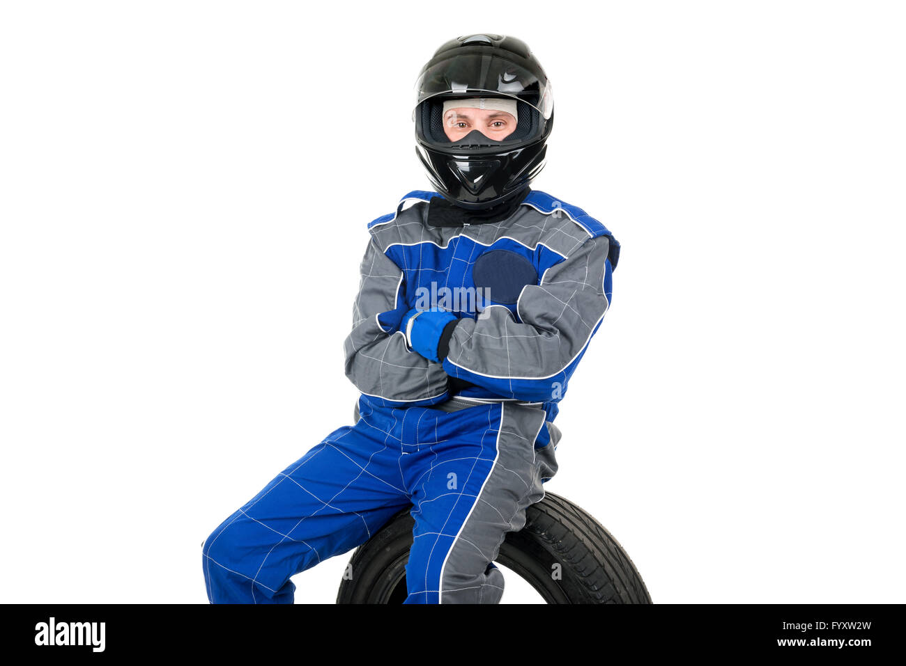 Racing driver posing in full gear isolated in white Stock Photo - Alamy