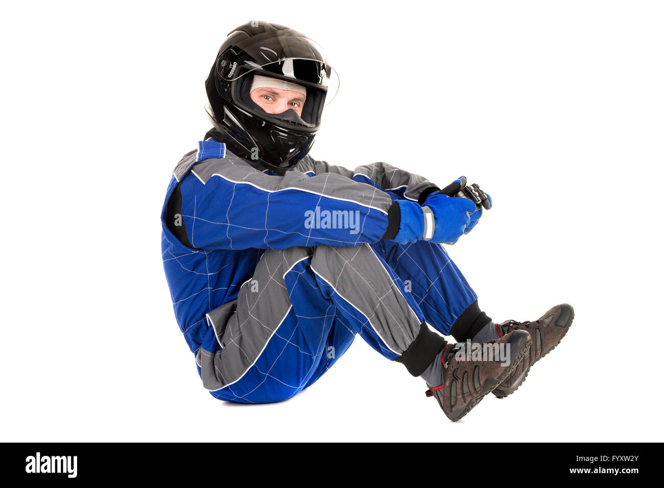 Racing driver posing in full gear isolated in white Stock Photo - Alamy