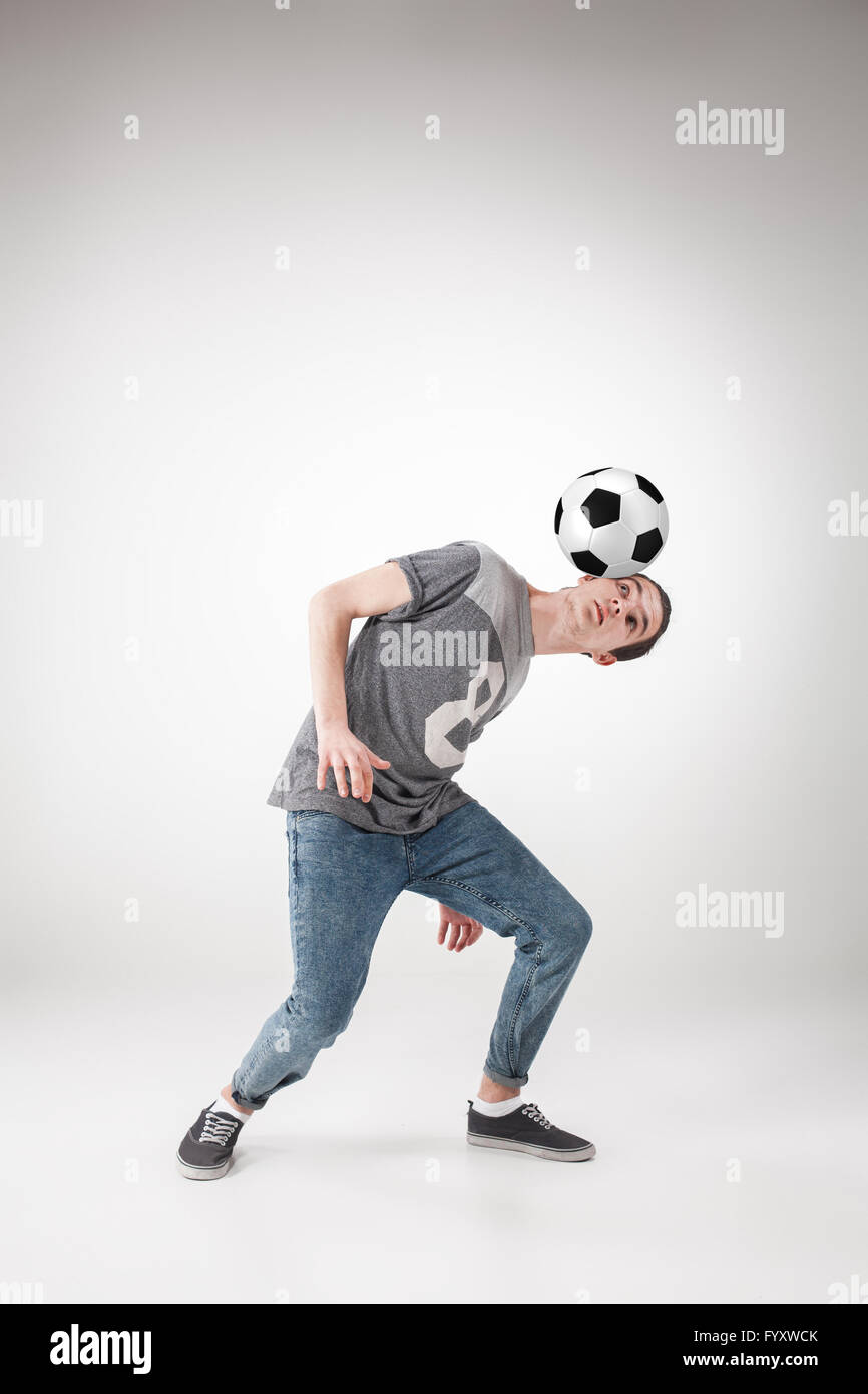 The guy with ball on gray background Stock Photo - Alamy