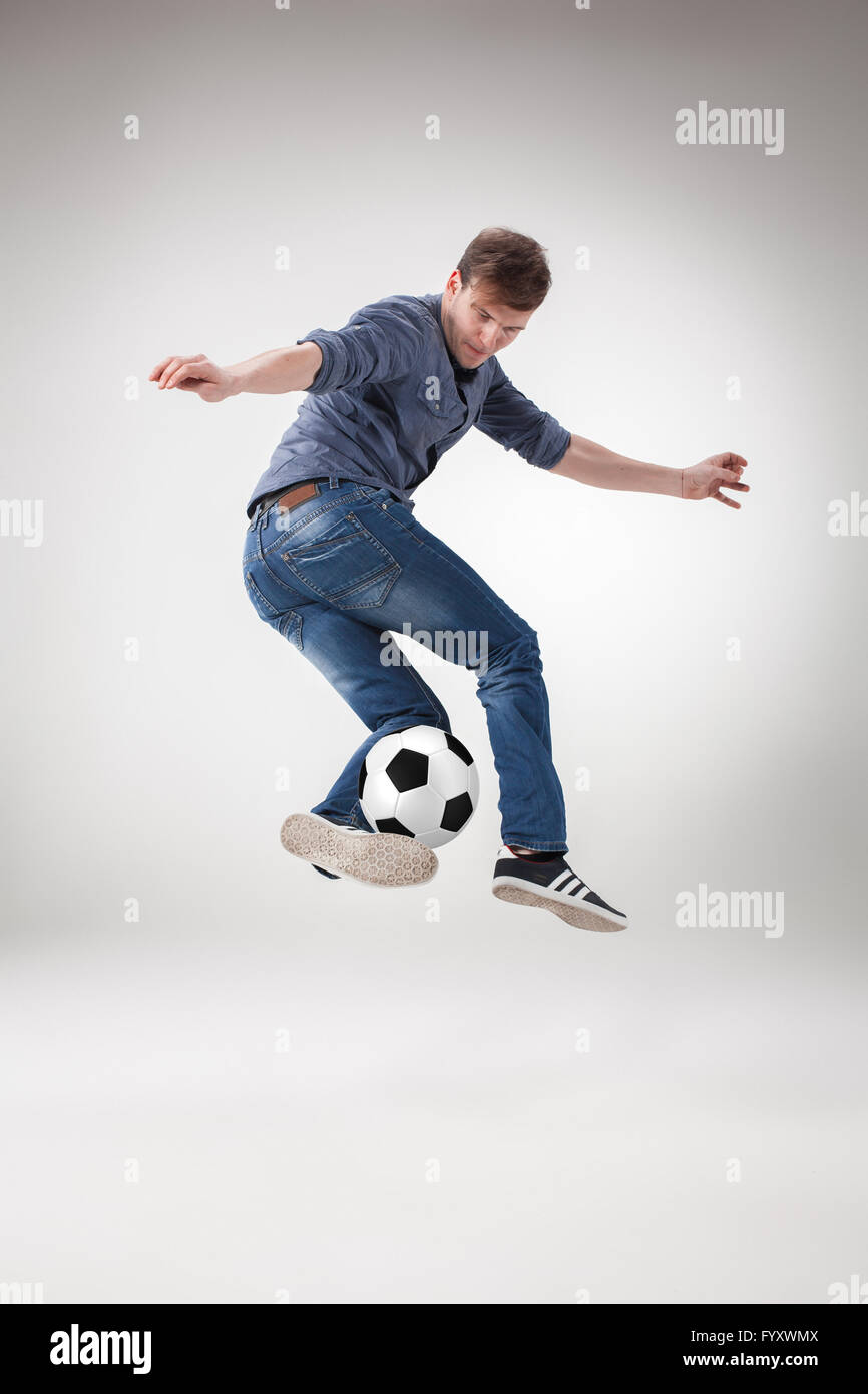 The guy with ball on gray background Stock Photo - Alamy