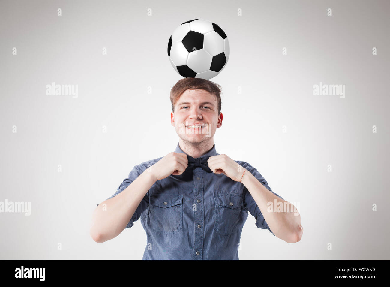 The guy with ball on gray background Stock Photo - Alamy