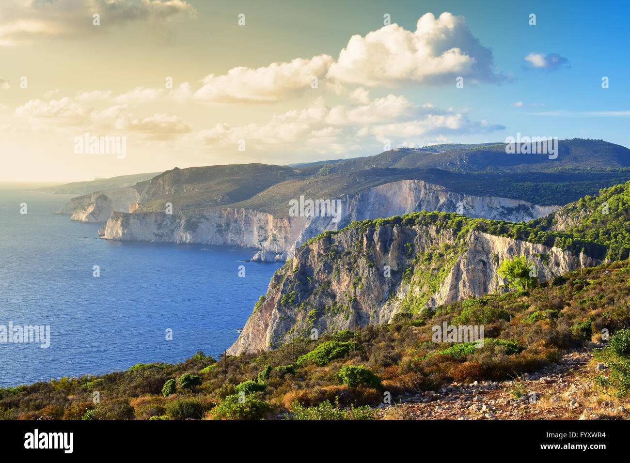 Seashore with cliff on the Greece in the summer Stock Photo - Alamy