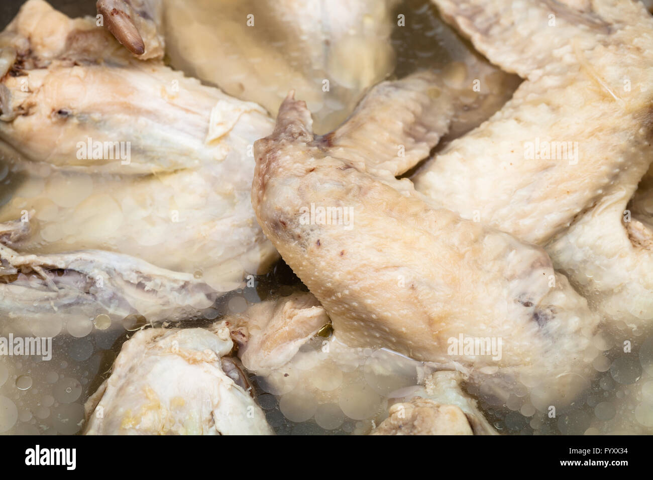 many boiled chicken wings in chicken bouillon close up Stock Photo - Alamy