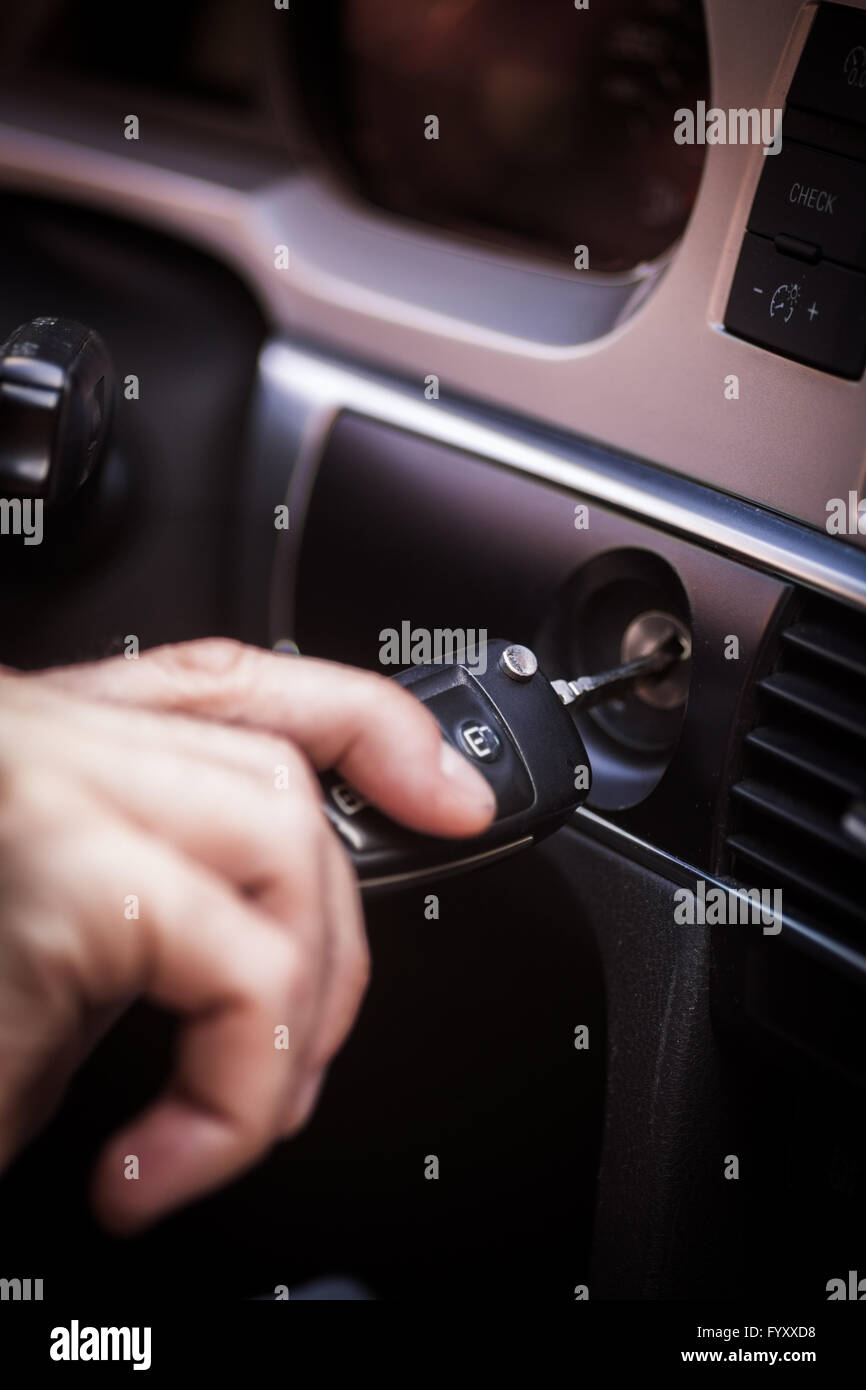 Color image of a hand inserting the ignition key of a car Stock Photo ...
