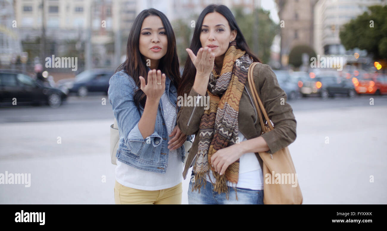 Two young women flirting with the camera Stock Photo - Alamy
