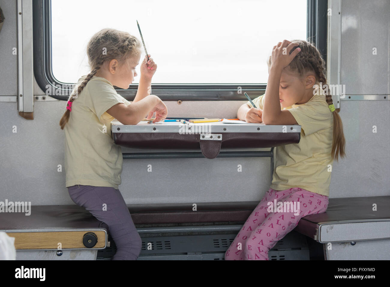 Two children sit side hi-res stock photography and images - Alamy