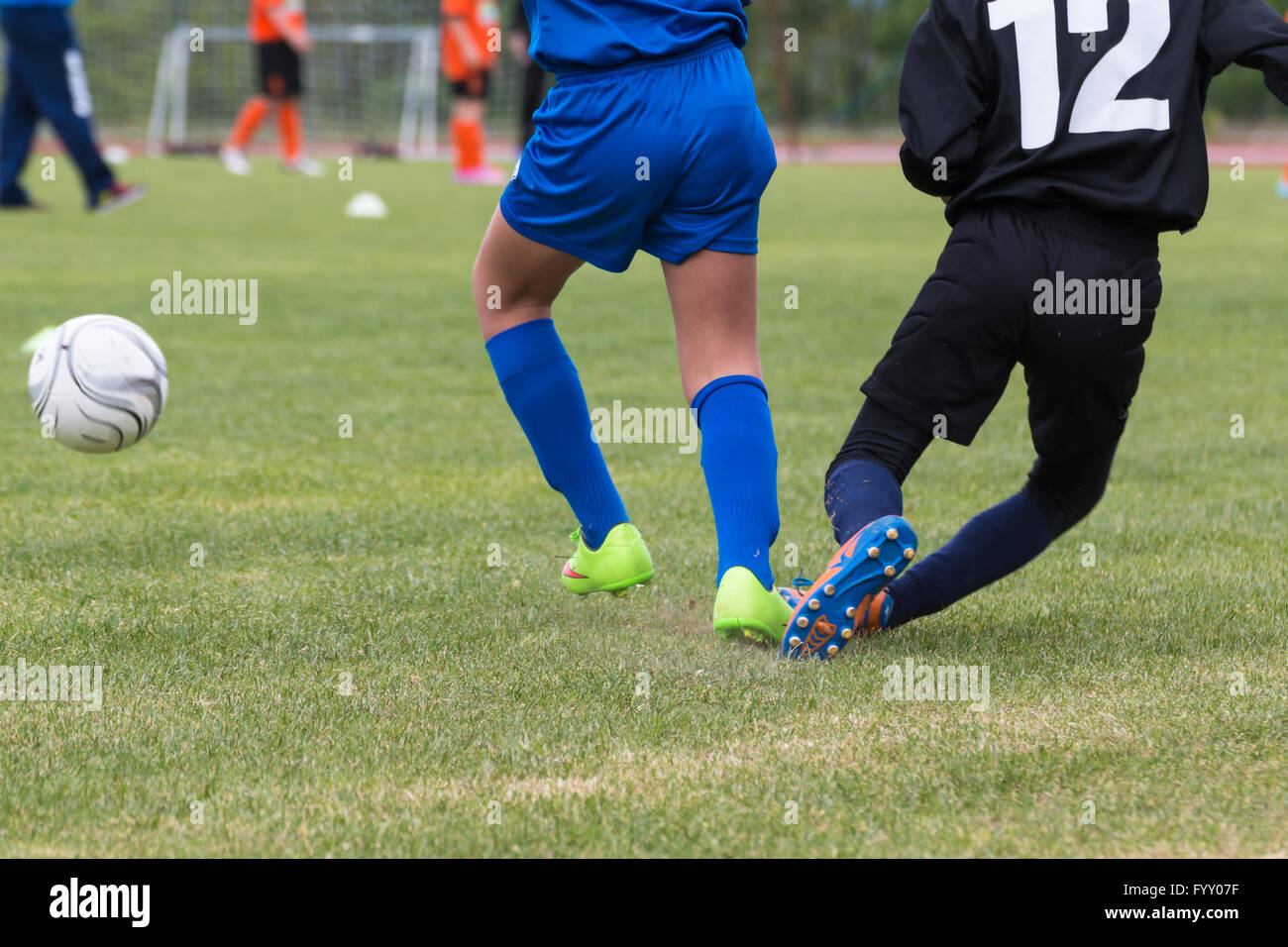 Little Soccer Players during Match, Goalkeeper, Defender and White Ball ...