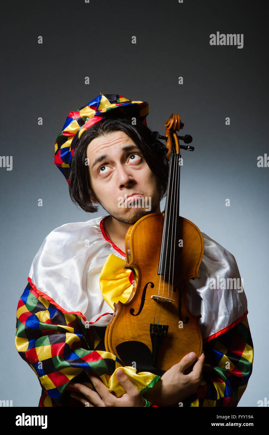 Funny violin clown player in musical concept Stock Photo - Alamy