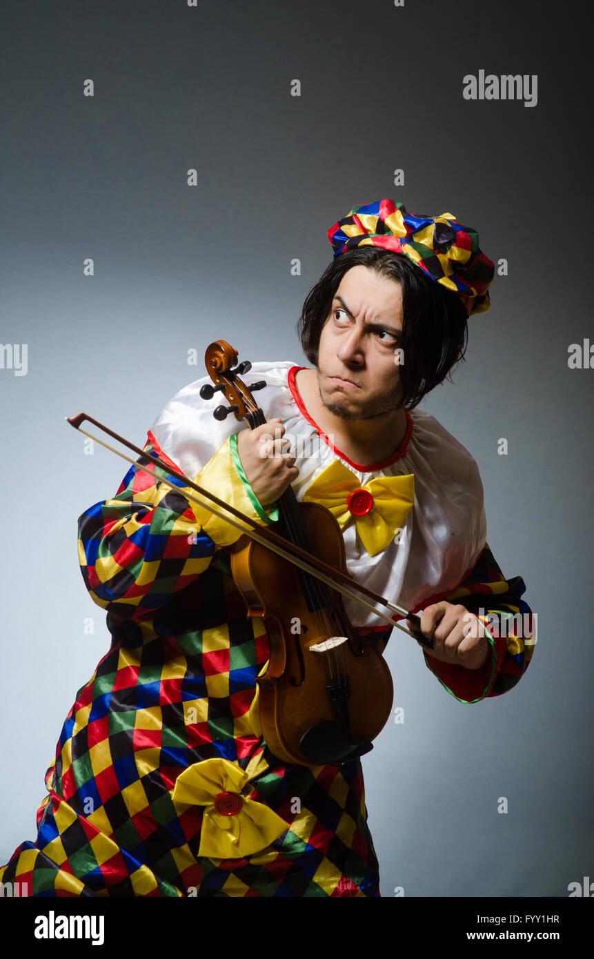Funny violin clown player in musical concept Stock Photo - Alamy