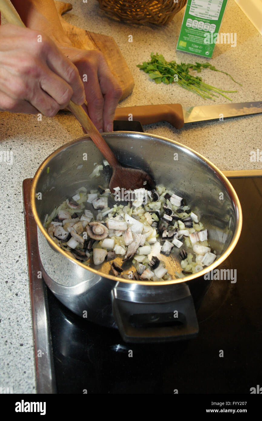 Cooking shaggy ink cap soup Stock Photo - Alamy