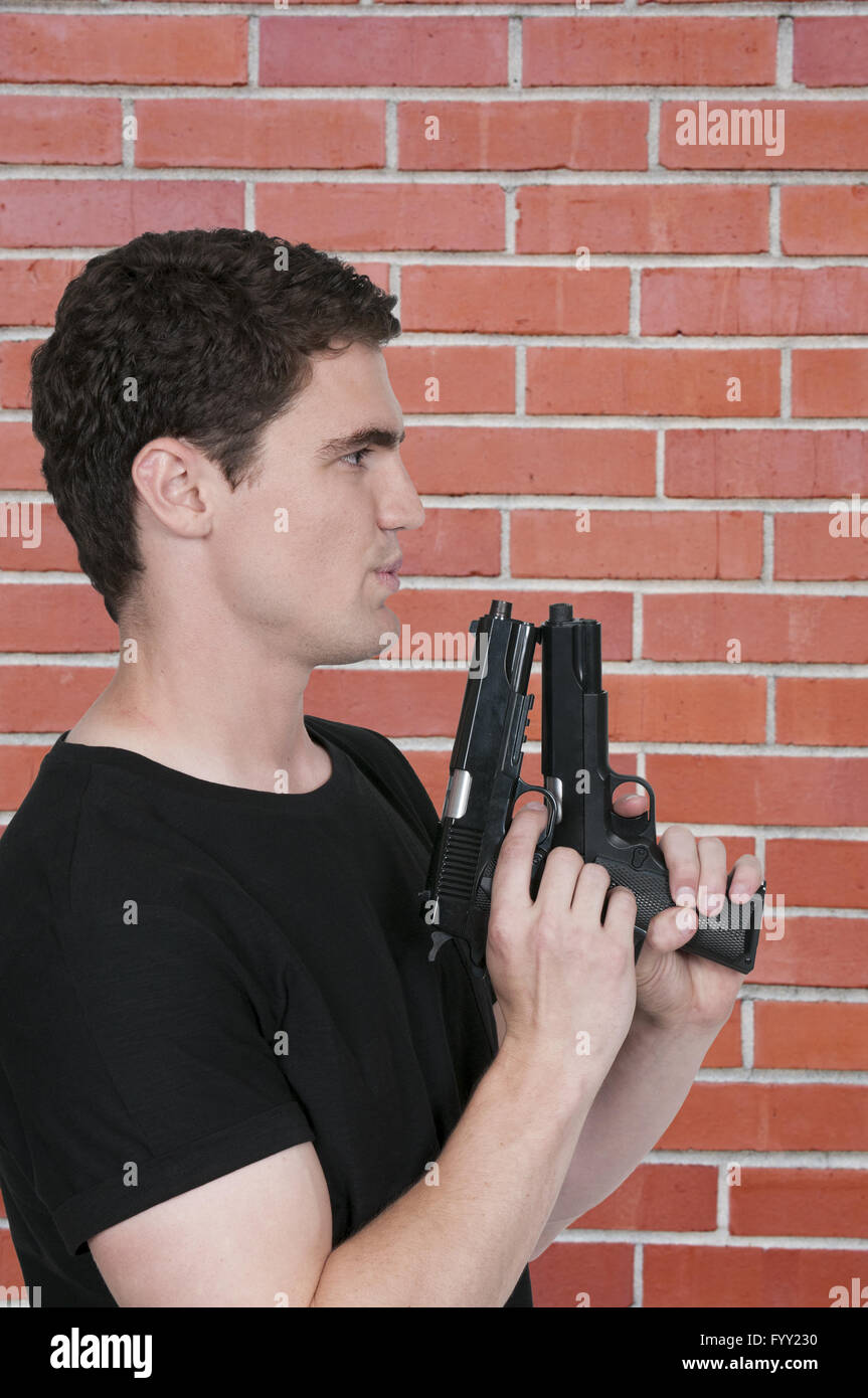 Man holding a pistol Stock Photo - Alamy