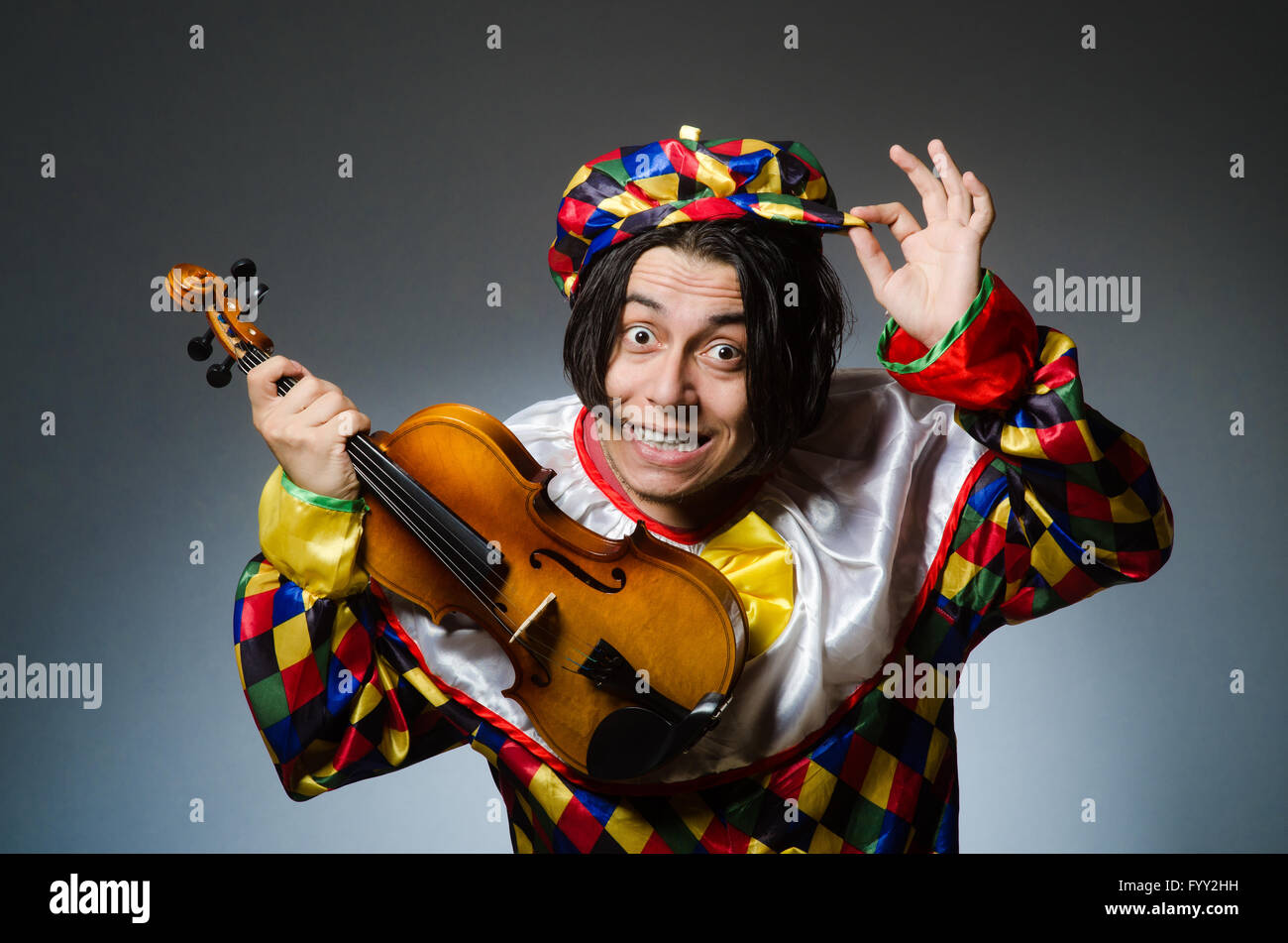 Funny violin clown player in musical concept Stock Photo - Alamy