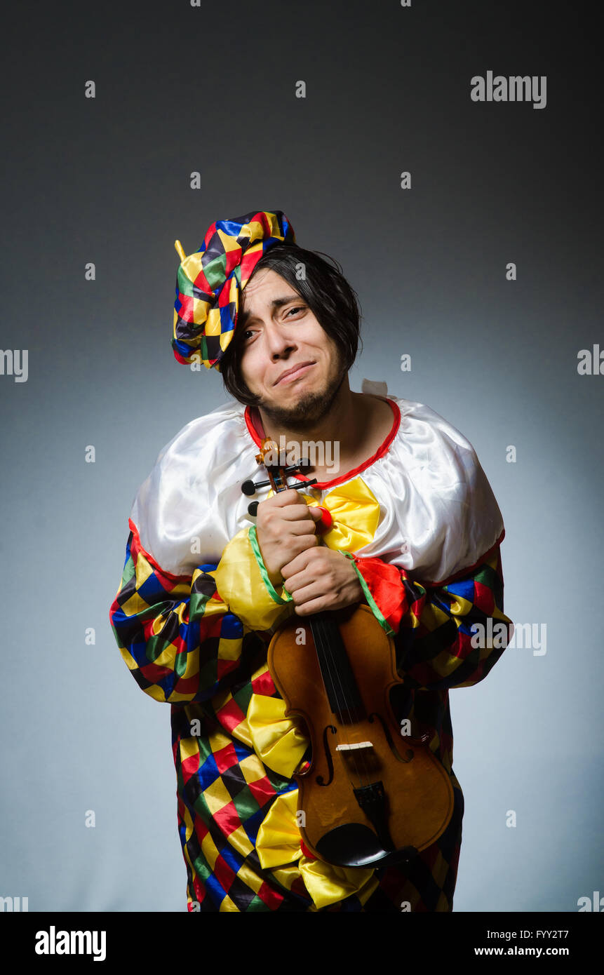 Funny violin clown player in musical concept Stock Photo - Alamy