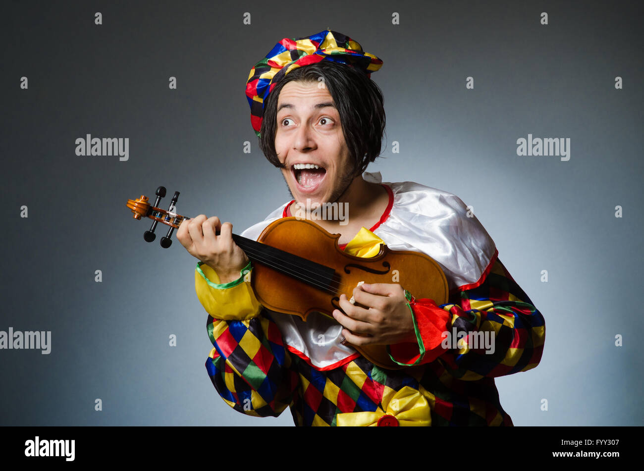 Funny violin clown player in musical concept Stock Photo - Alamy