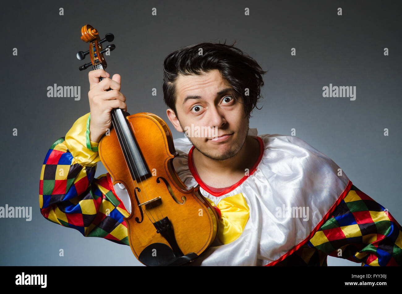 Funny violin clown player in musical concept Stock Photo - Alamy
