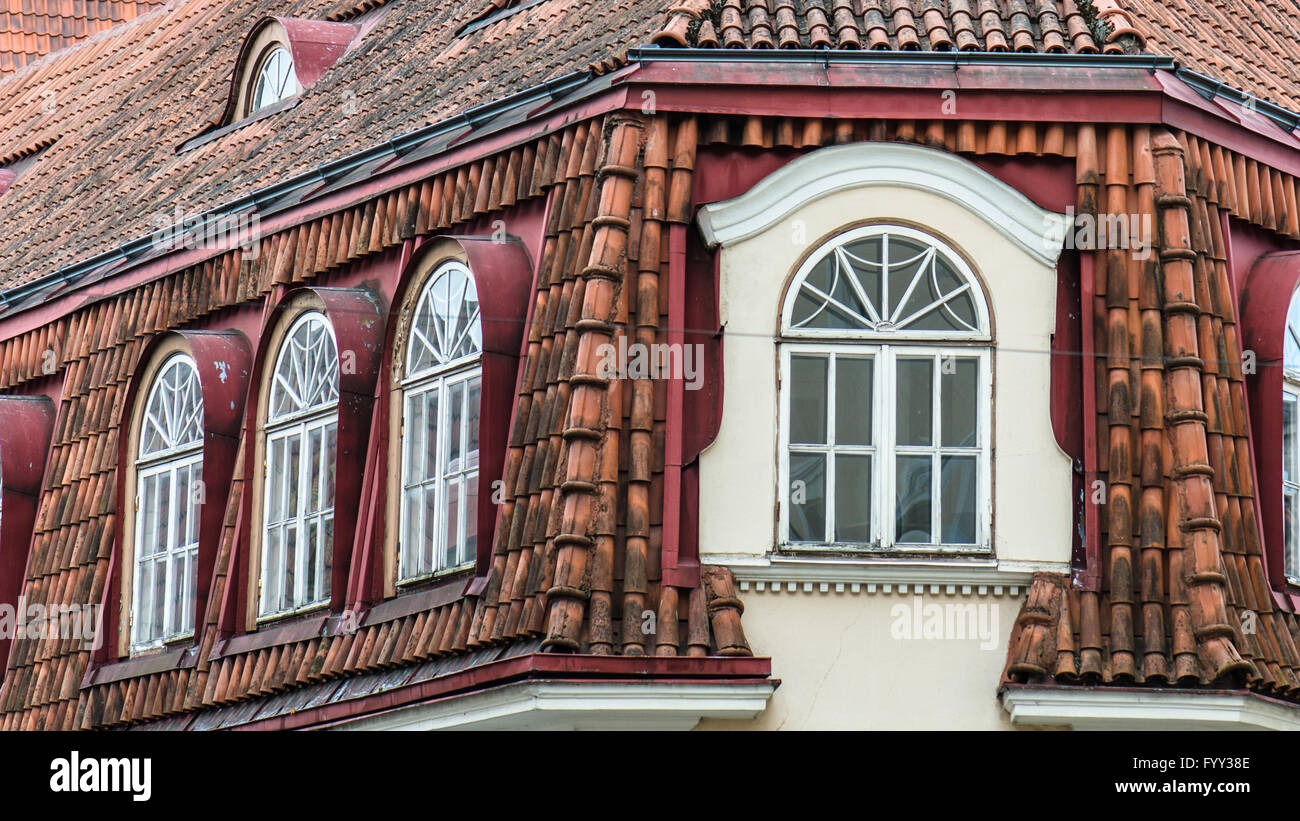 Mansard windows on a tile roof of the house in Tallinn, a close up ...