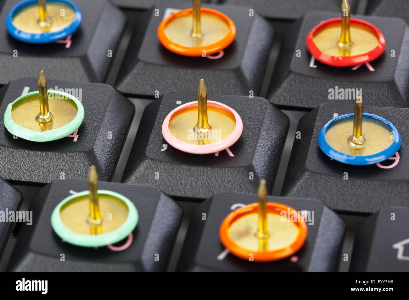 Pins on computer keyboard Stock Photo - Alamy