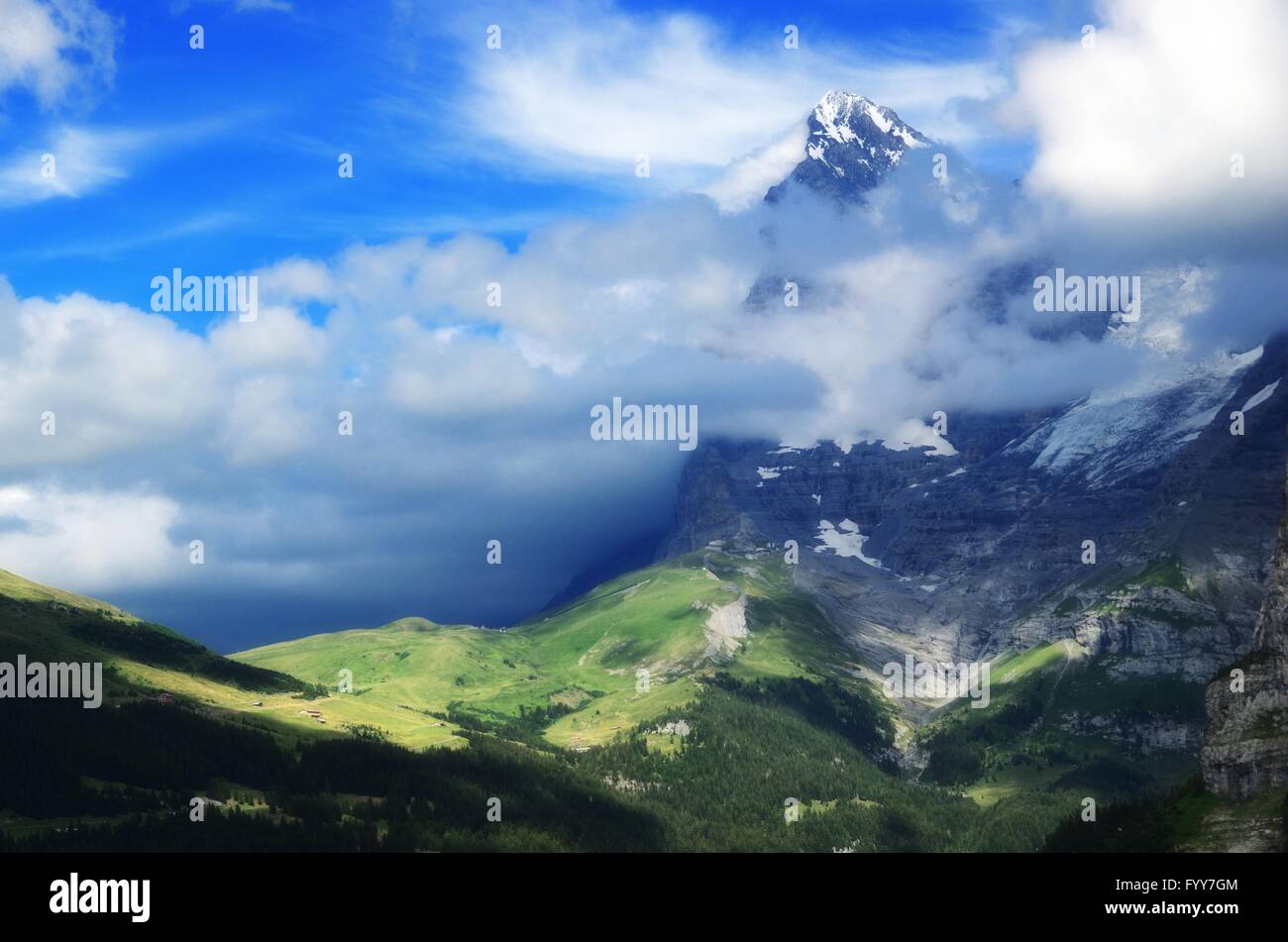 Eiger with sun, clouds and blue sly Stock Photo - Alamy