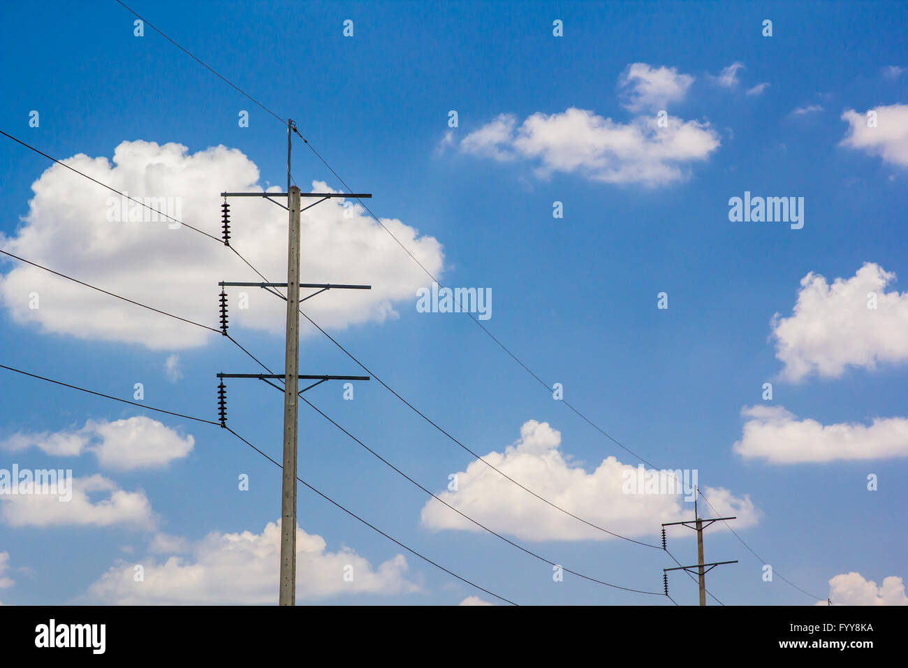 Electricity post and clouds blue sky background Stock Photo - Alamy