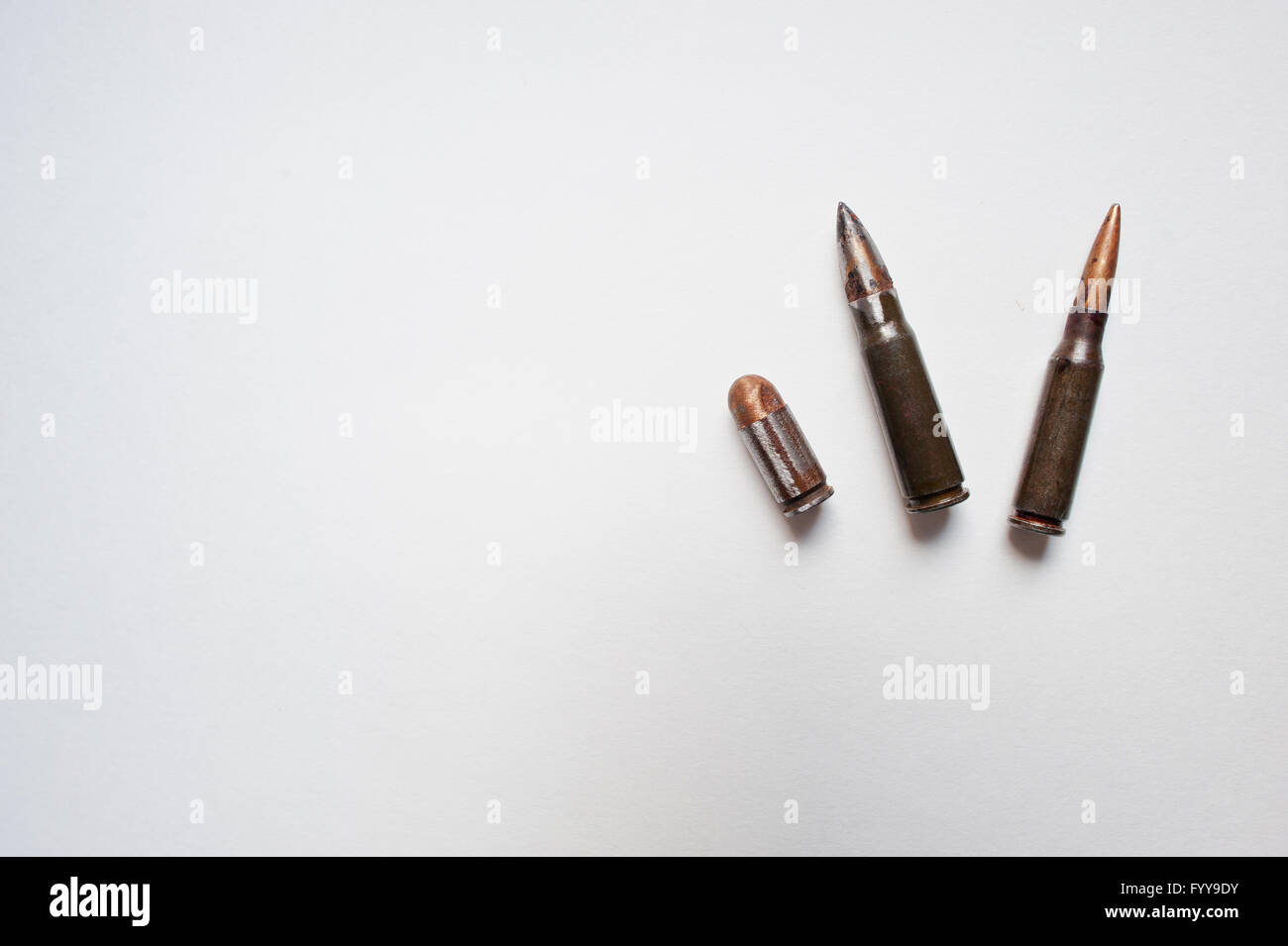 Three rifle and pistol bullets on white background Stock Photo - Alamy