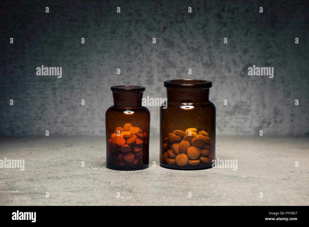 Glass bottles with pills on stone table. Concept of medicine ...