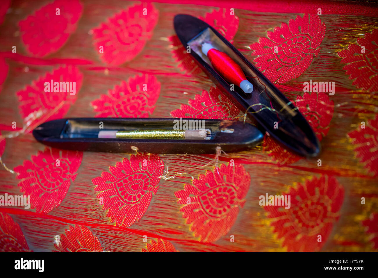 Red and Golden swing 2 hand looms rolls © Jahangir Alam Onuchcha/Alamy ...
