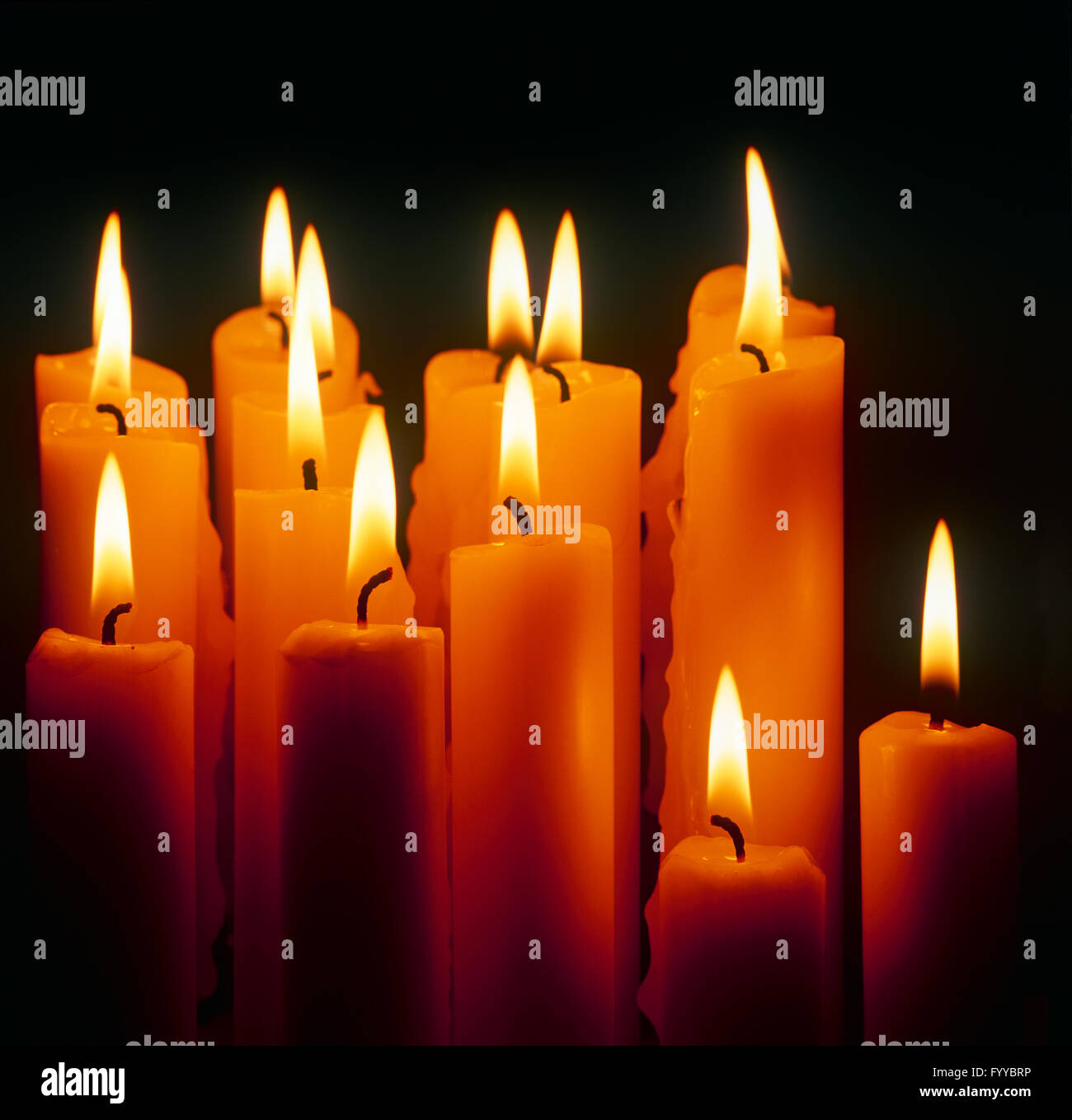 A bunch of lit candles, inside Stock Photo - Alamy