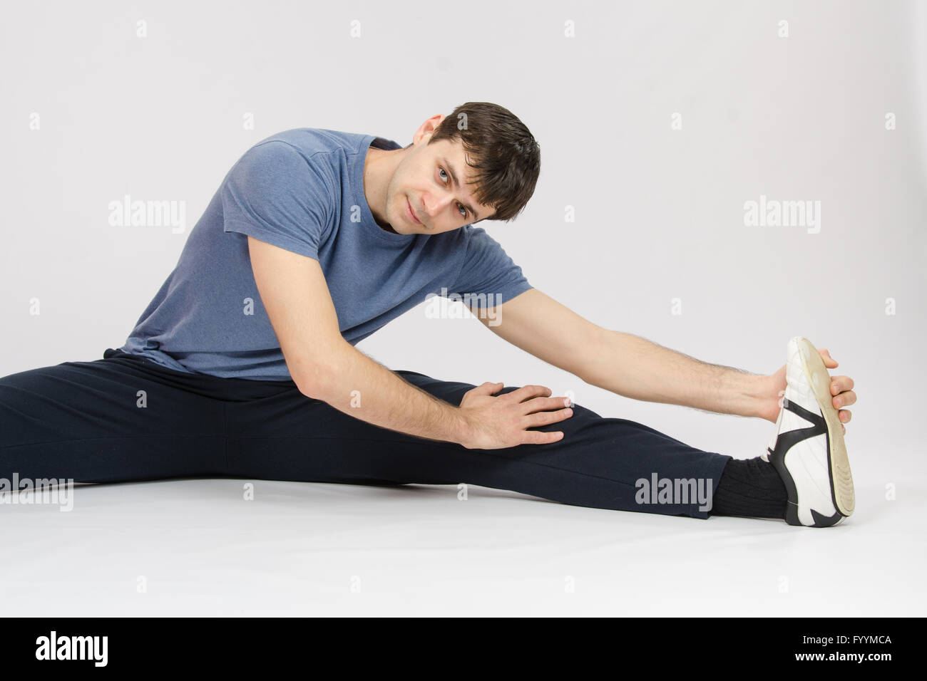Athlete stretches the muscles of left leg Stock Photo - Alamy