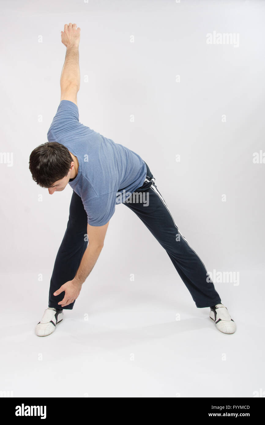 Athletes perform Mahi hands reach for the right foot Stock Photo - Alamy
