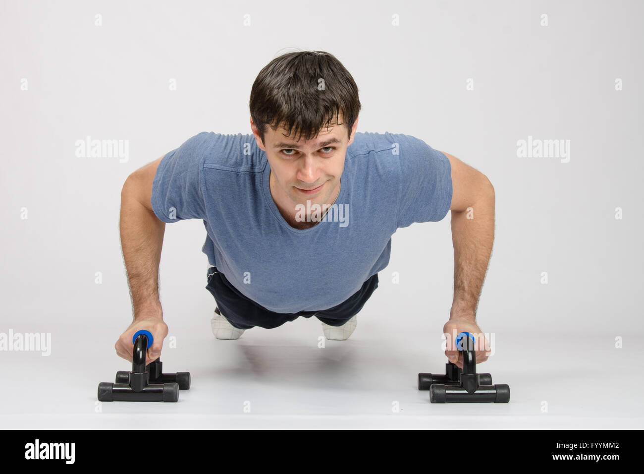 The athlete is pushed off the floor on legs Stock Photo - Alamy