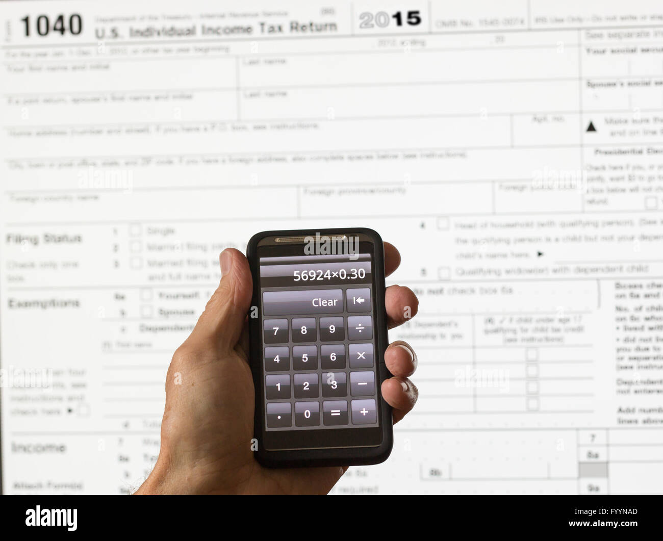 USA tax form 1040 for year 2015 and calculator Stock Photo - Alamy
