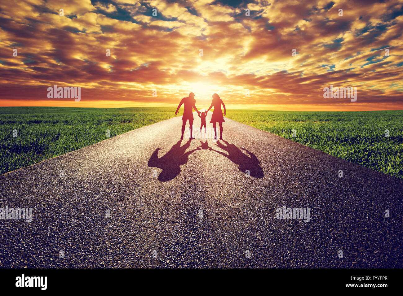 Family walk on long straight road Stock Photo - Alamy
