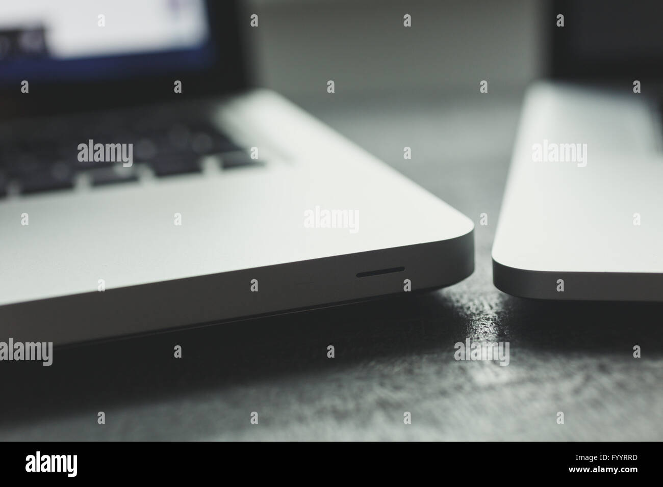 Two laptops on modern wooden desk Stock Photo - Alamy