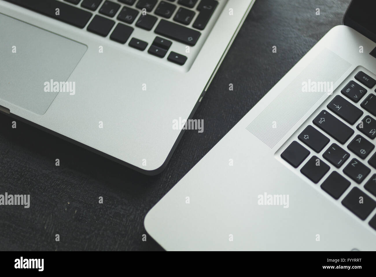 Two laptops on modern wooden desk Stock Photo - Alamy
