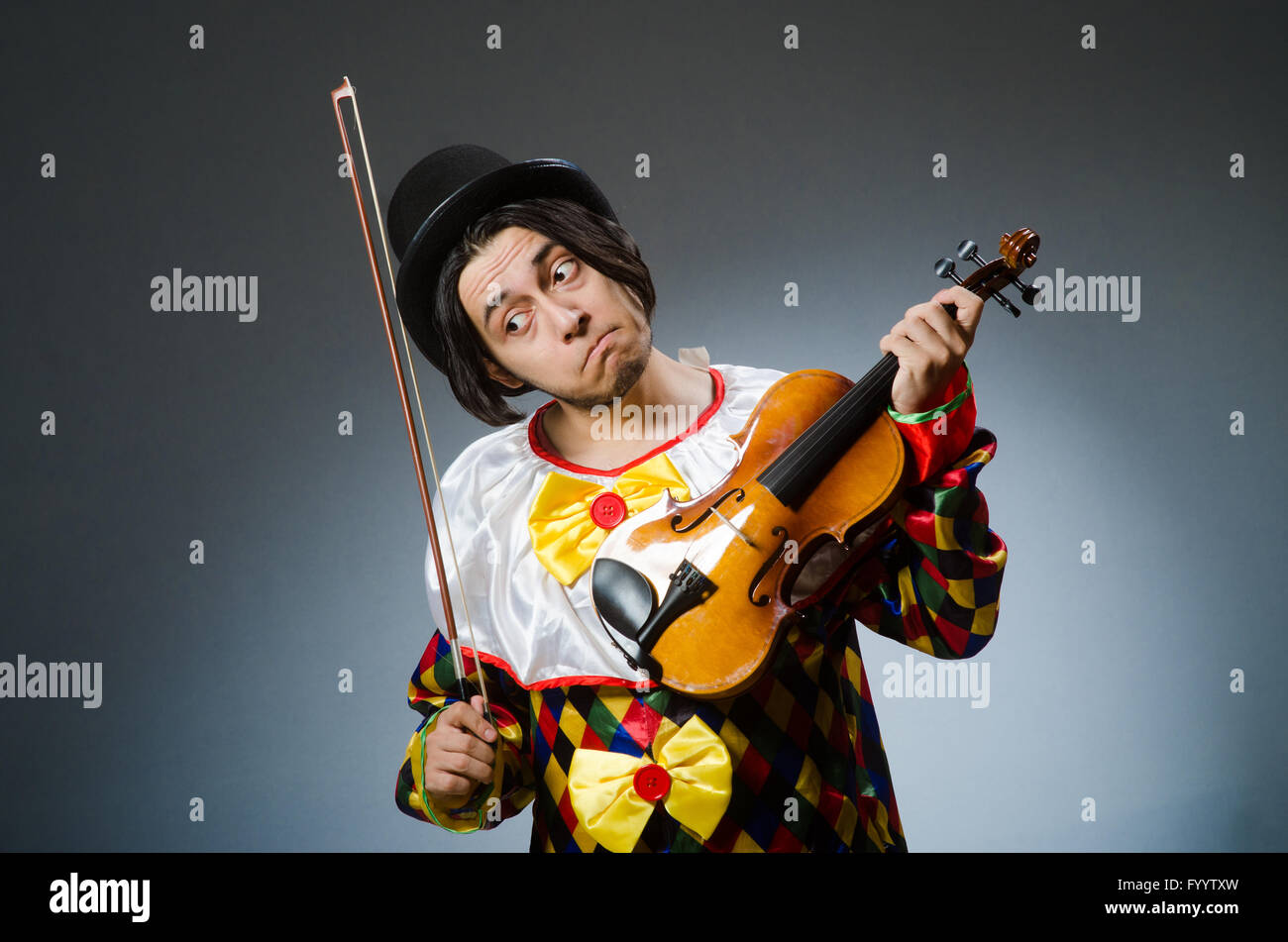 Funny violin clown player in musical concept Stock Photo - Alamy