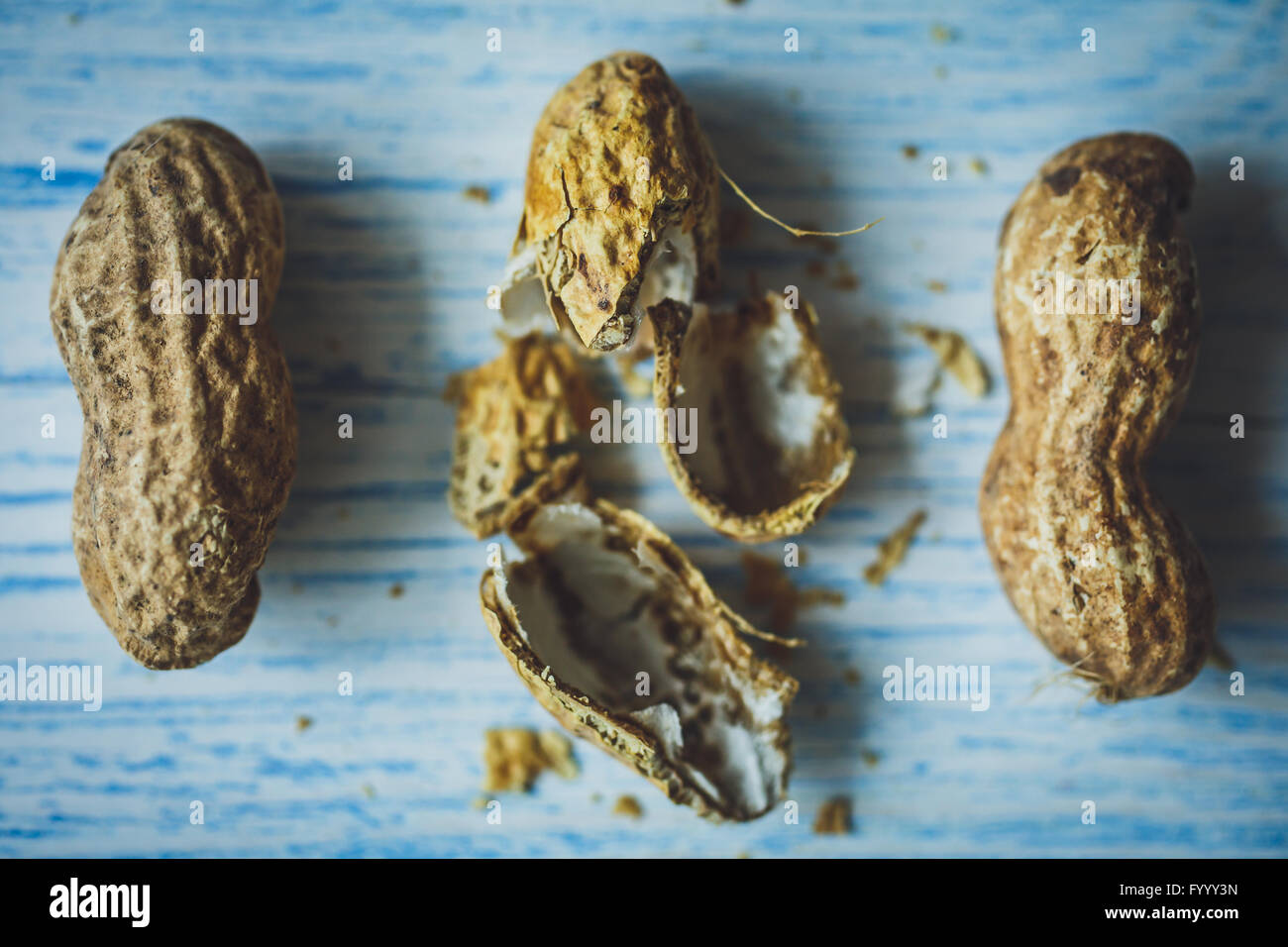 Fresh peanuts in shell on blue desk Stock Photo - Alamy