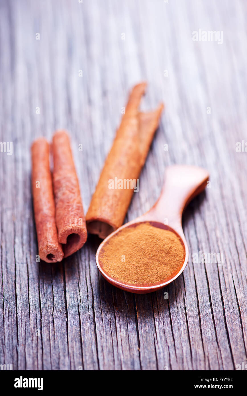 cinnamon in spoon and on a table Stock Photo - Alamy