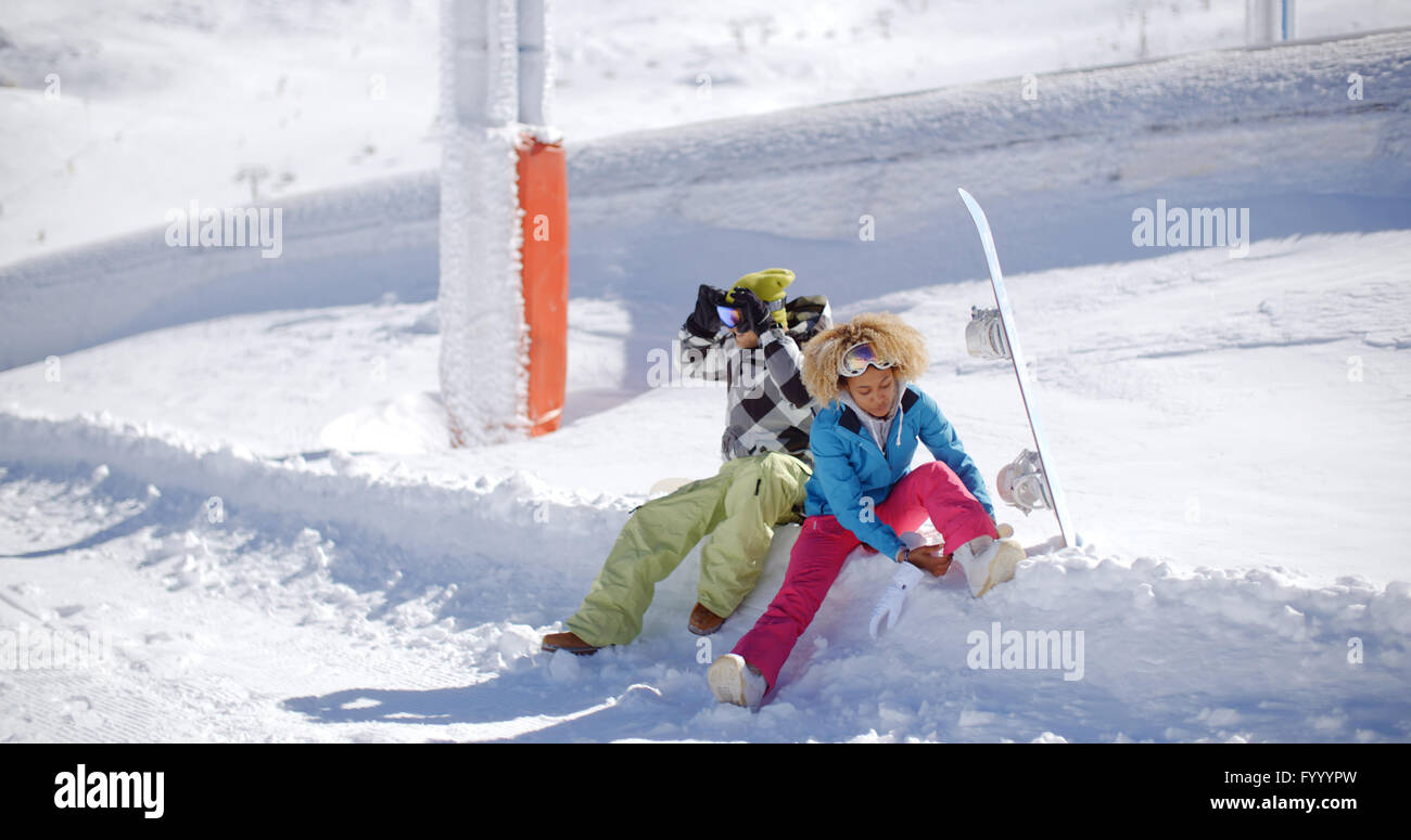Young couple getting ready to go snowboarding Stock Photo - Alamy