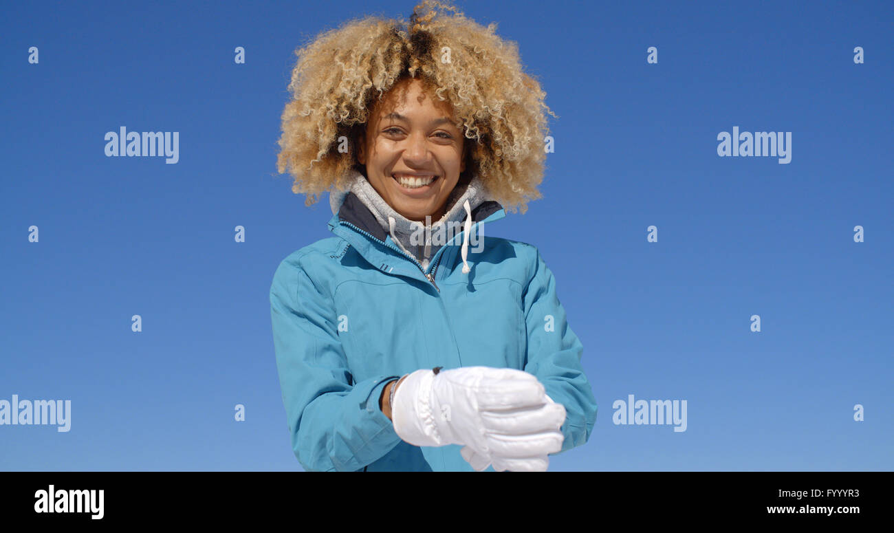 Cute woman in frizzy hair and winter coat Stock Photo - Alamy