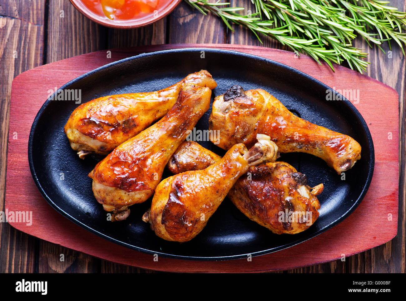 baked legs in bowl and on a table Stock Photo - Alamy