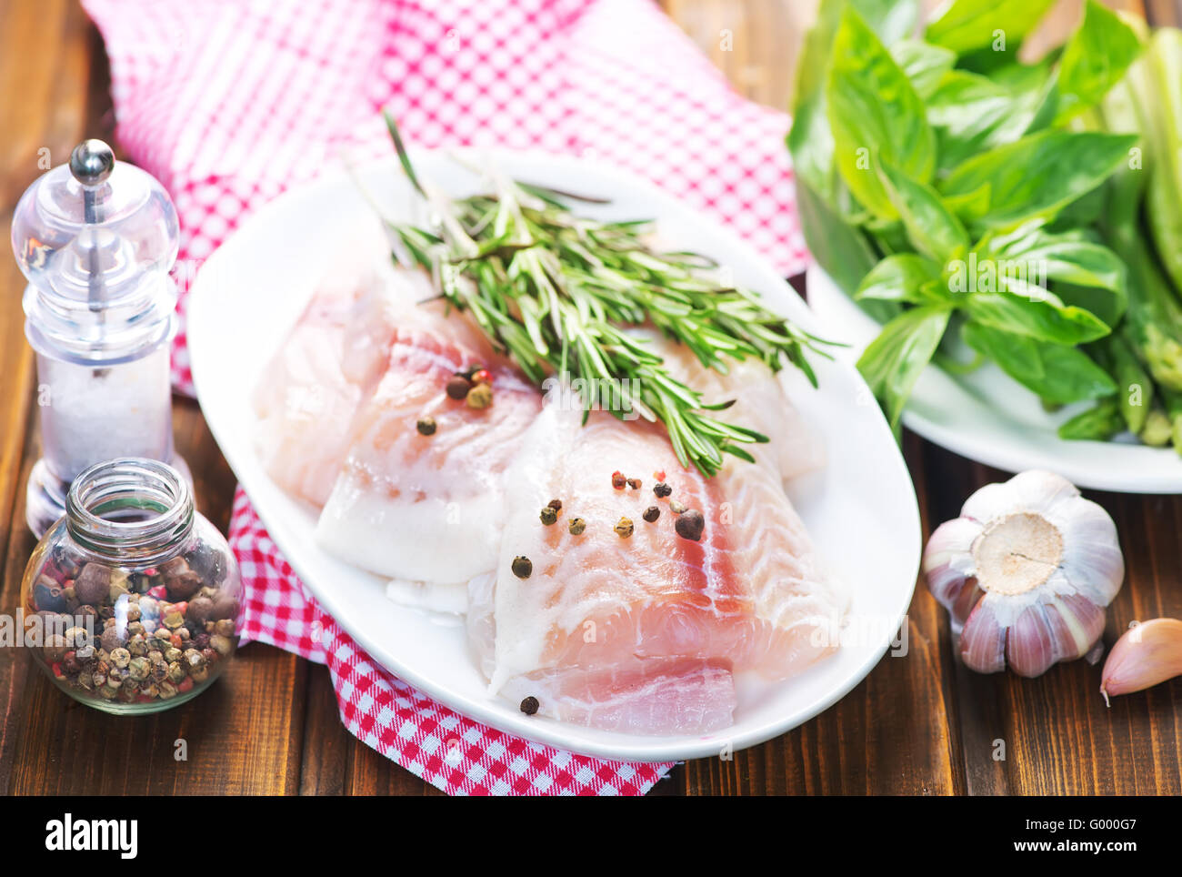 raw fish with spice and pepper on a table Stock Photo - Alamy