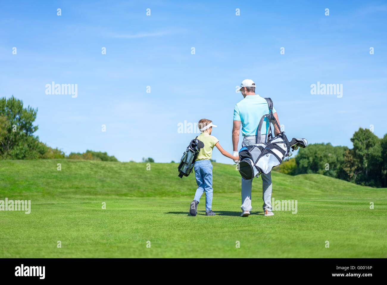 Family on golf course Stock Photo - Alamy