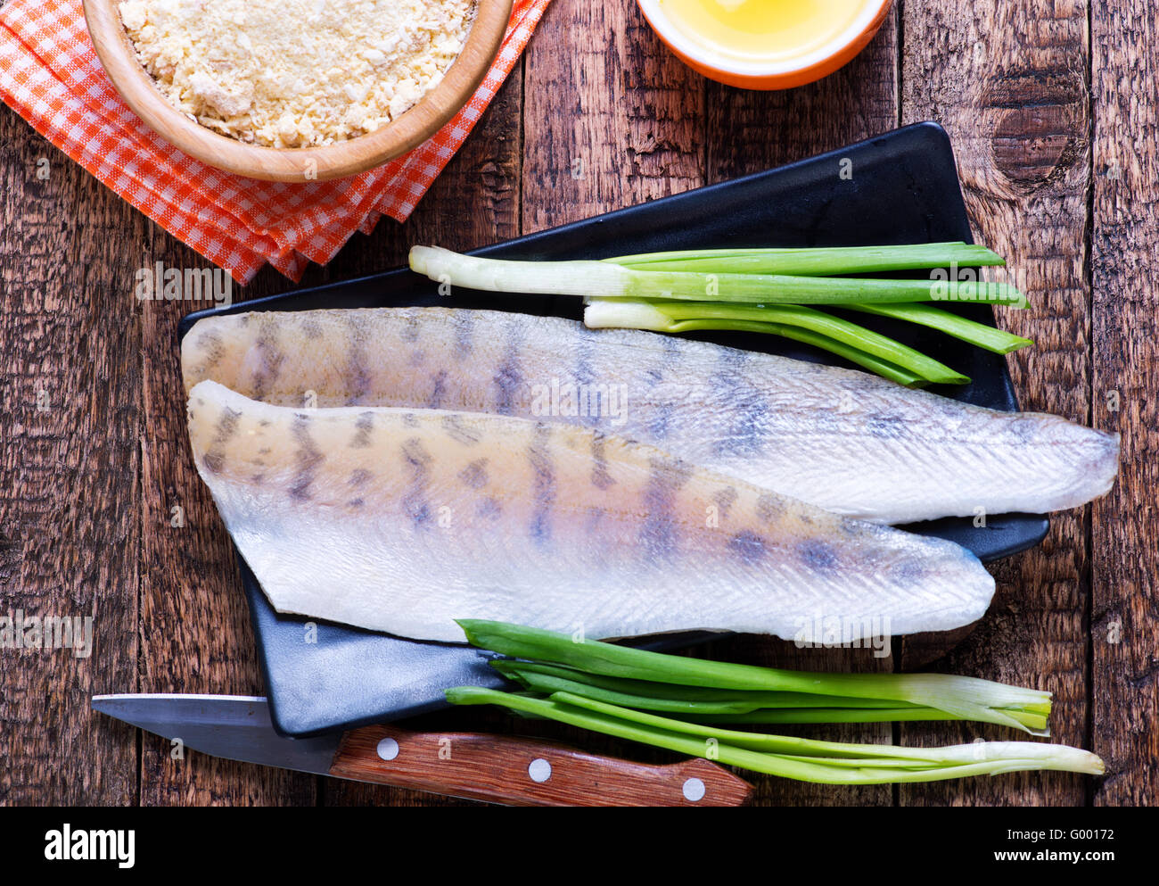 raw fish on plate and on a table Stock Photo - Alamy