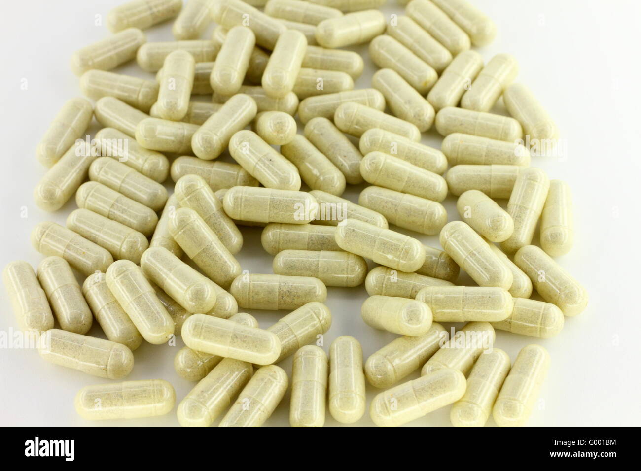 Green medication capsules on white background Stock Photo - Alamy