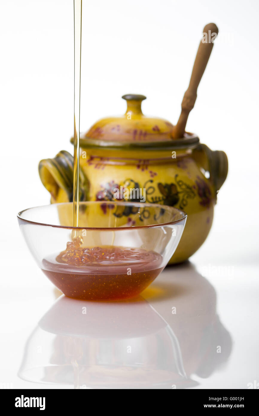 Filling the honey jar Stock Photo - Alamy