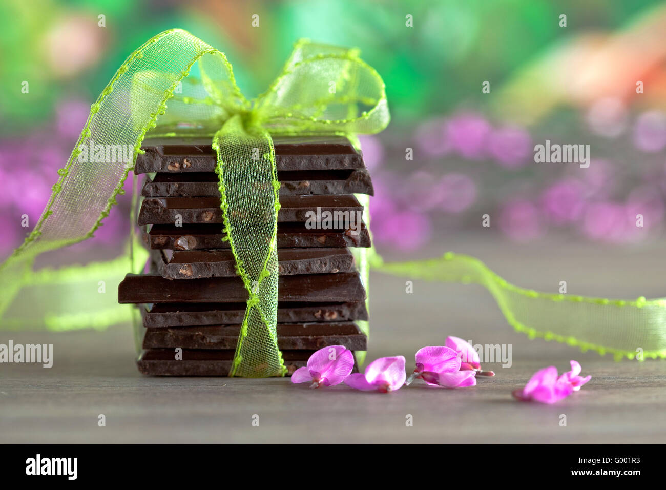 Decorative Stack of Chocolate with green ribbon and small pink flowers ...