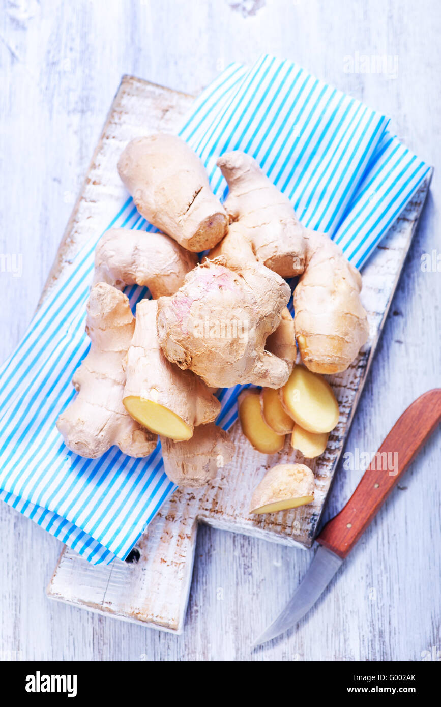 fresh ginger on board and on a table Stock Photo - Alamy