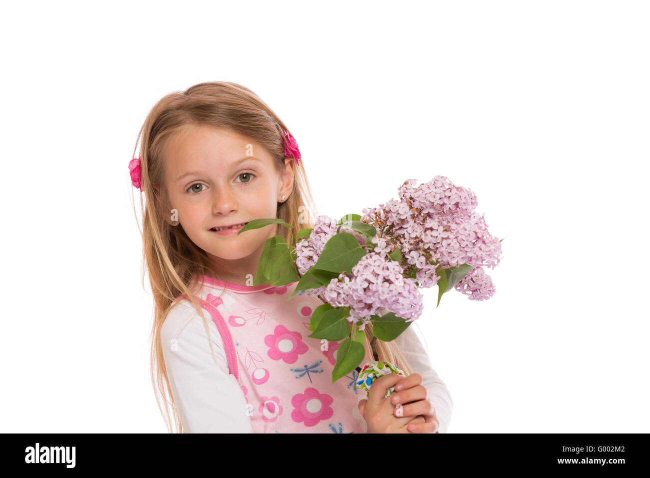 Happy little girl with lilac flowers Stock Photo - Alamy