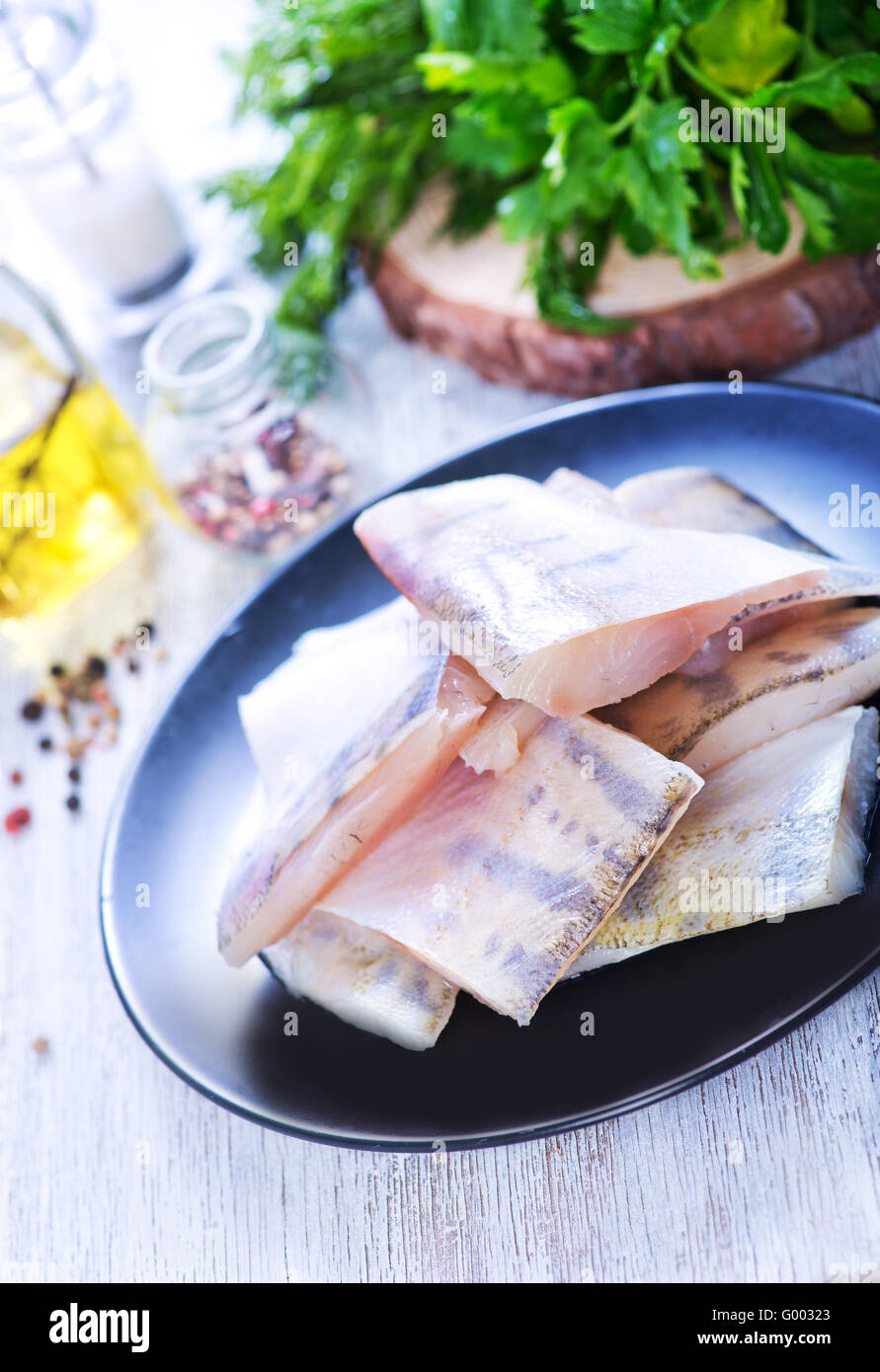 raw fish fillet on plate and on a table Stock Photo - Alamy