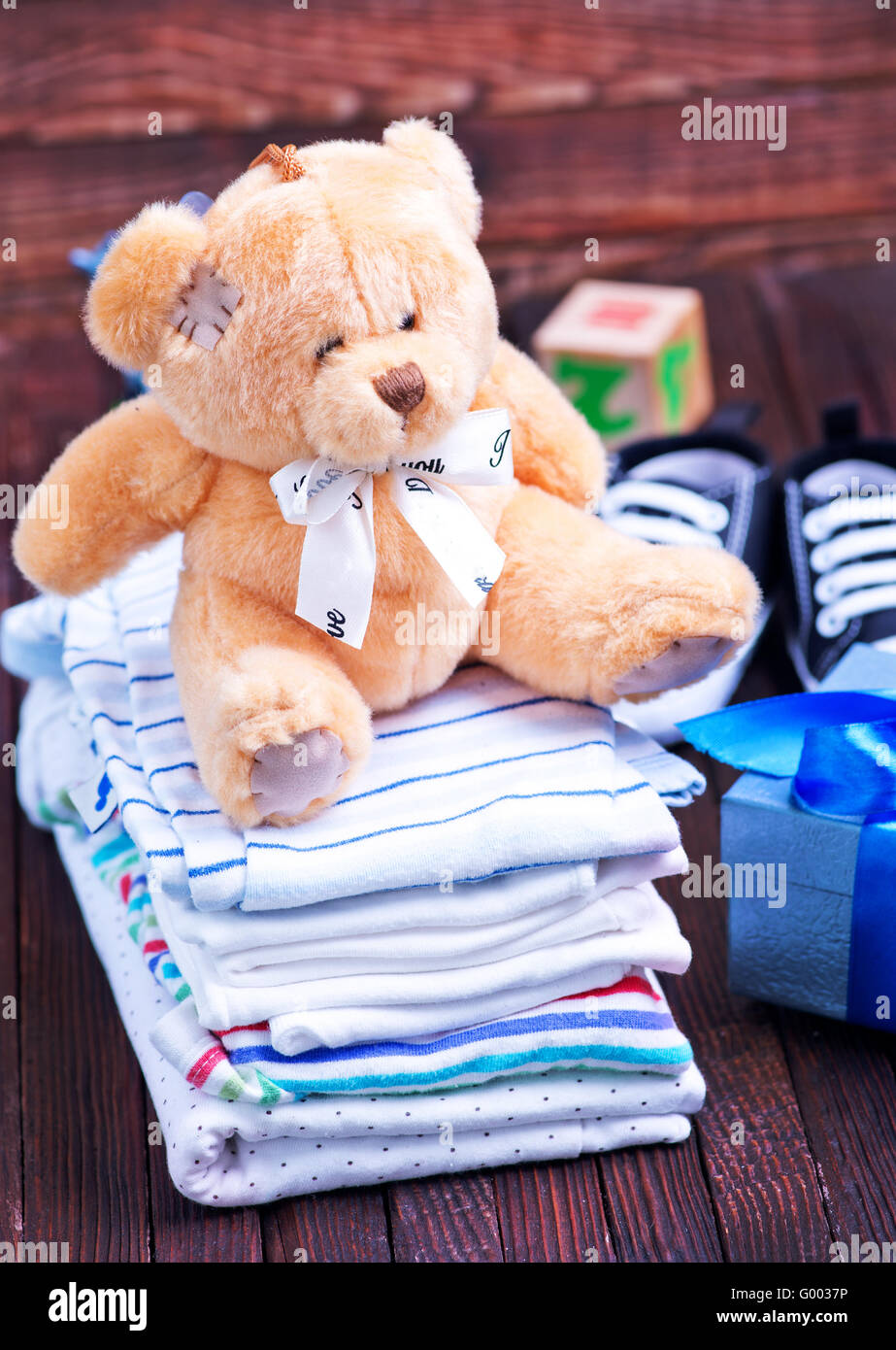 baby clothes and shoes on the wooden table Stock Photo - Alamy